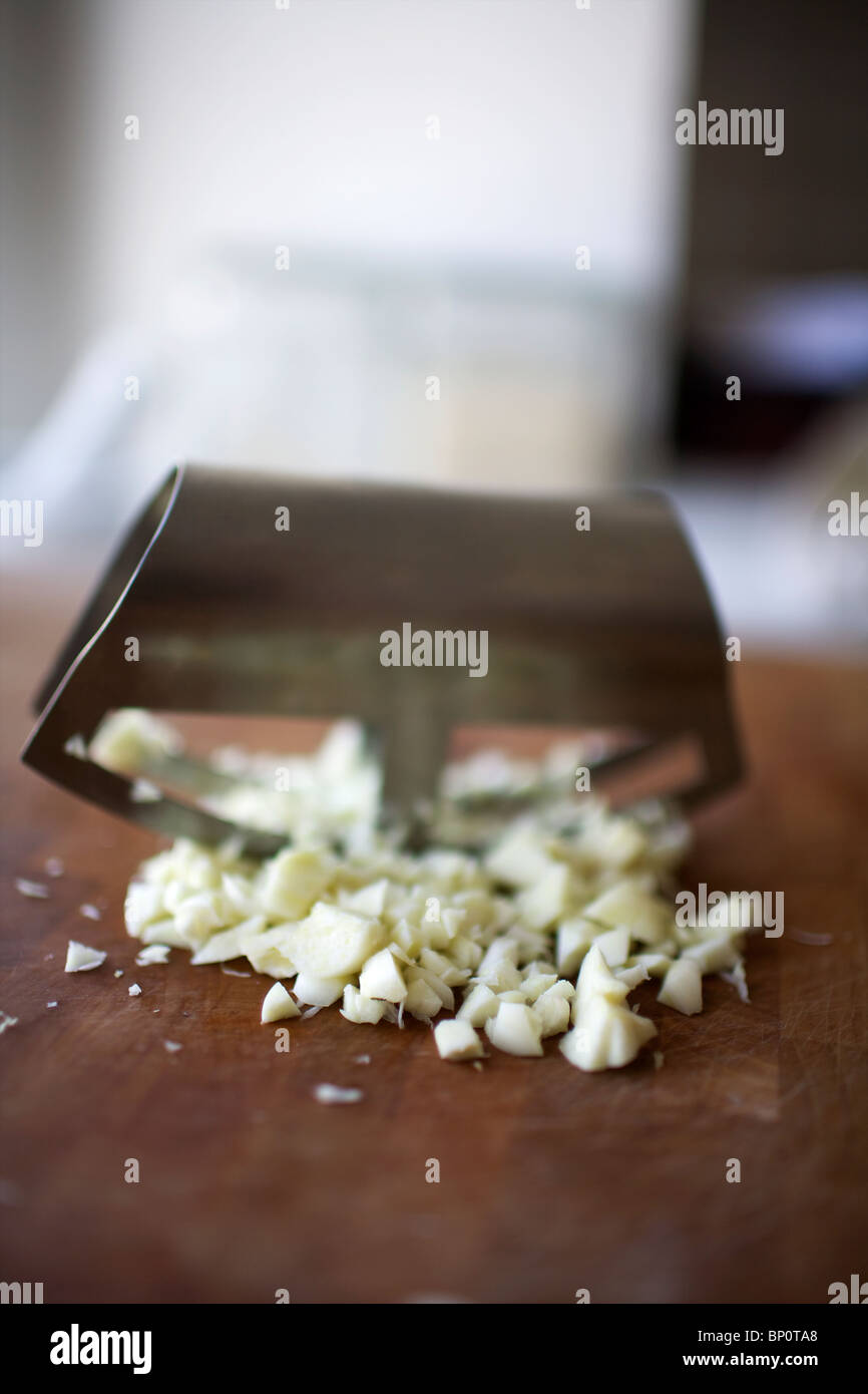 Garlic being cut for cooking Stock Photo - Alamy