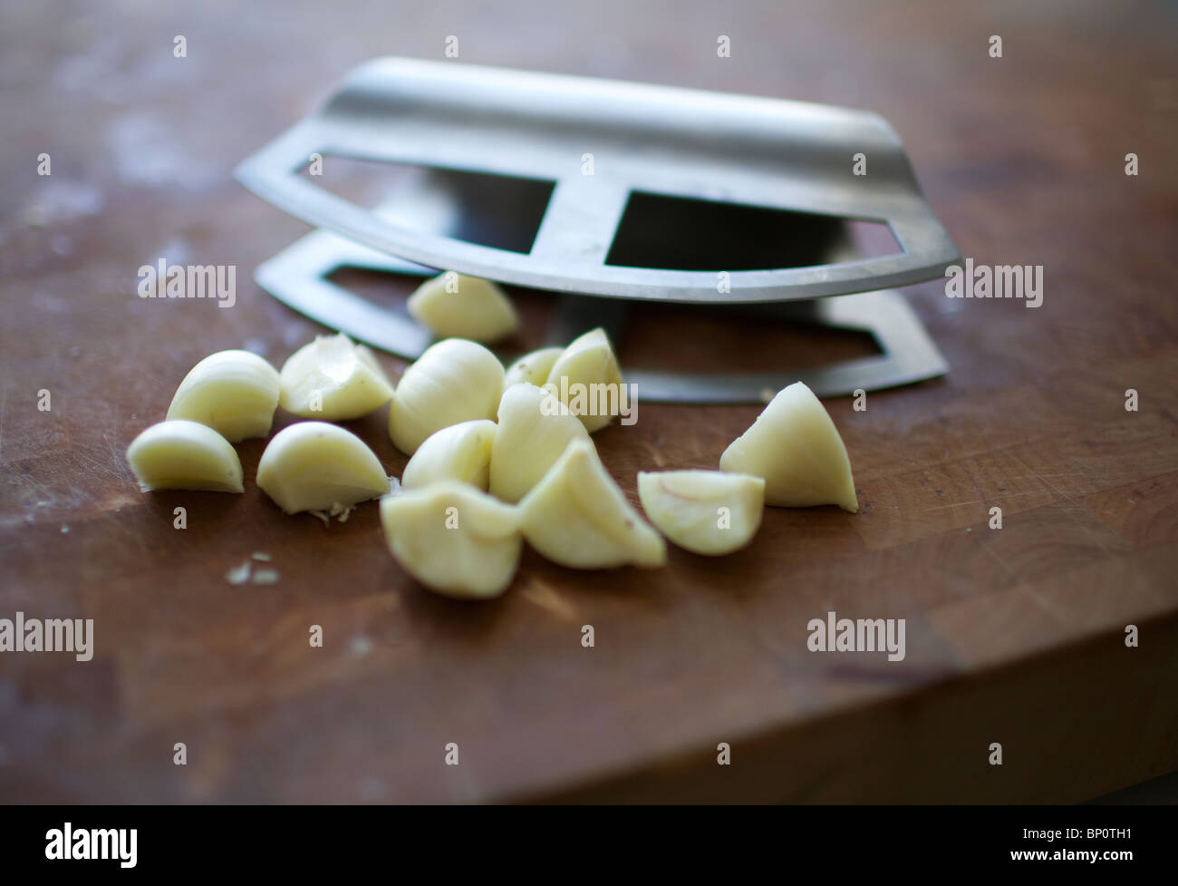 Garlic being cut for cooking Stock Photo - Alamy
