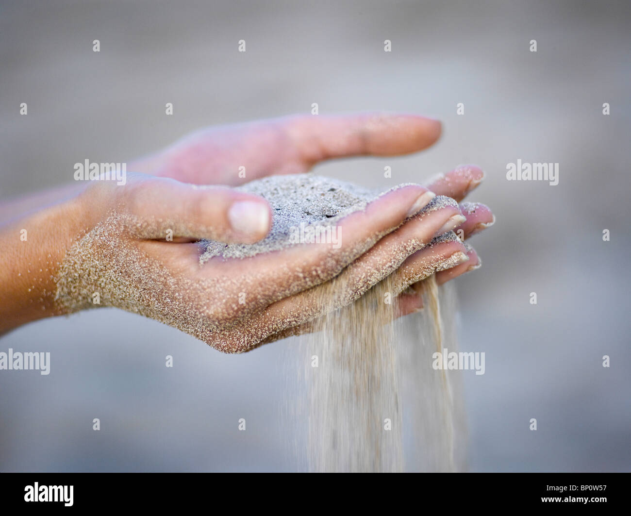 Woman's hands with sand Stock Photo - Alamy