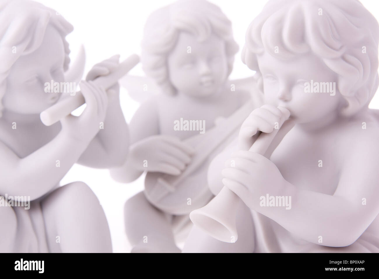 Macro photography of isolated porcelain figurines of angels playing ...