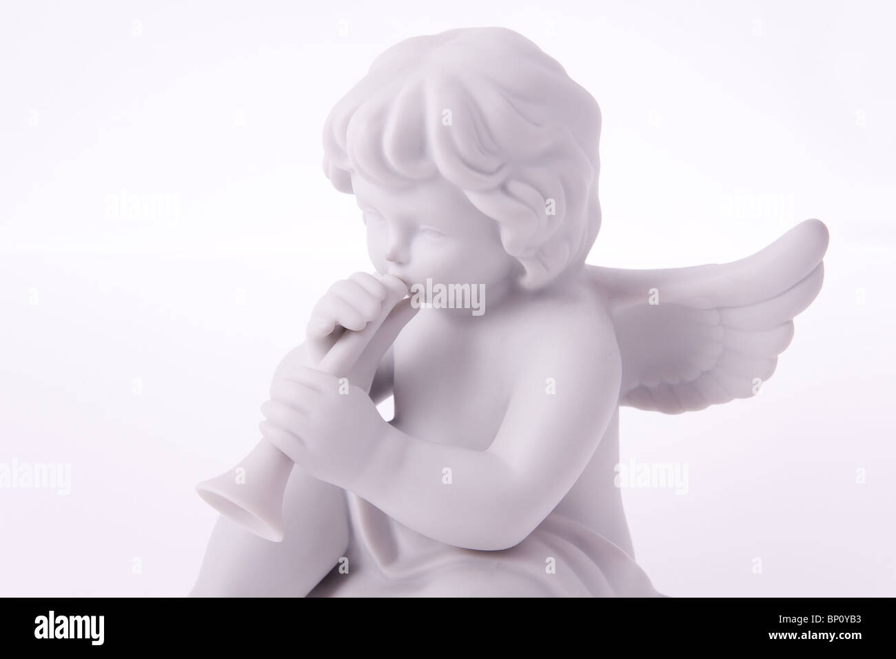 Macro photography of porcelain figurine of angel playing trumpet Stock ...