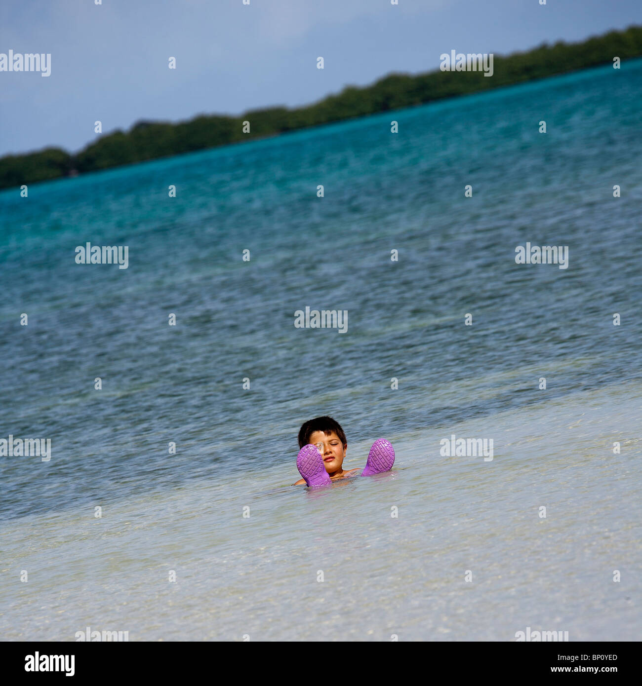 boy floating in the Caribbean sea waters. Bonaire, Netherland Antilles ...