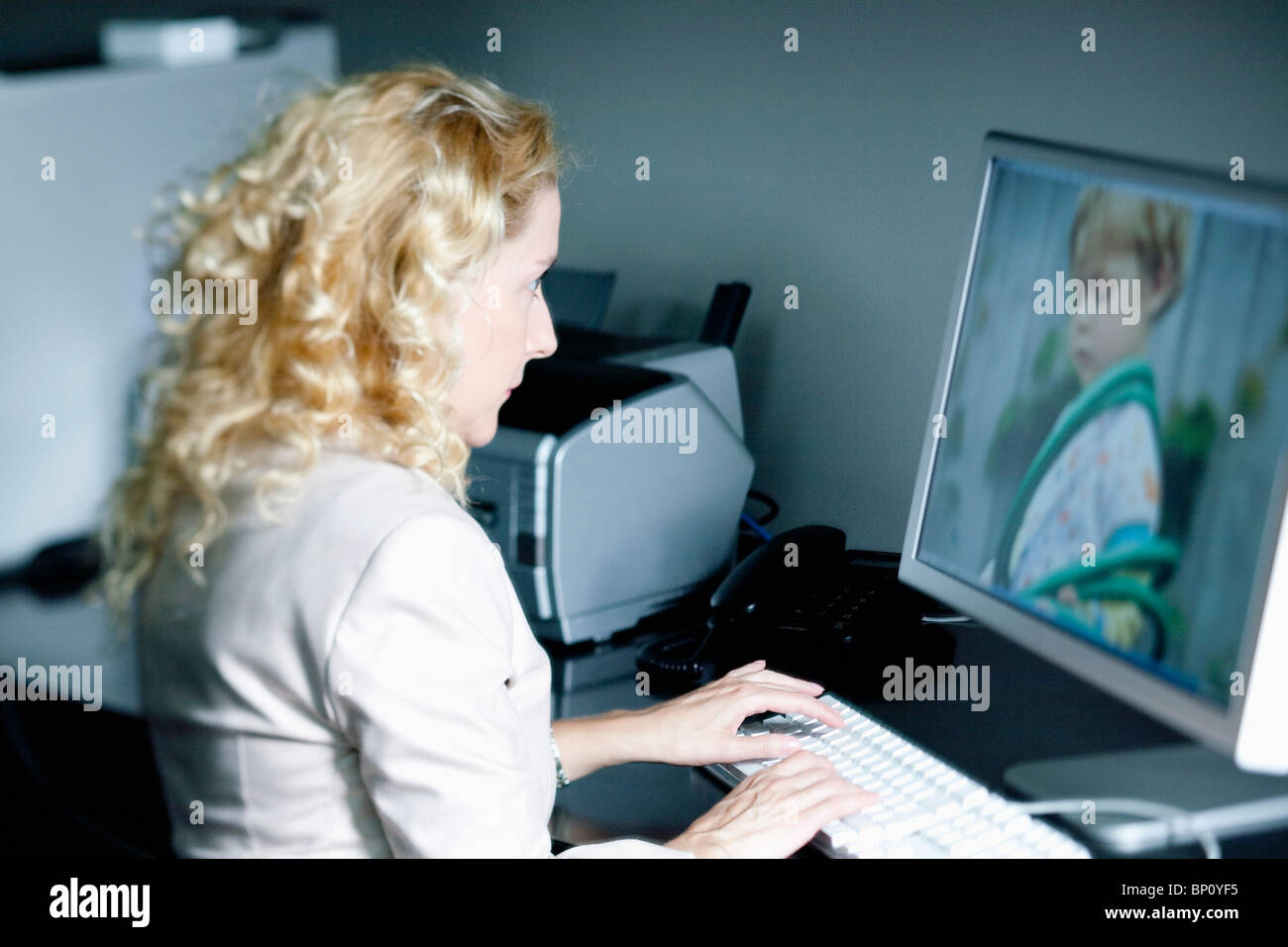 Woman using computer Stock Photo - Alamy