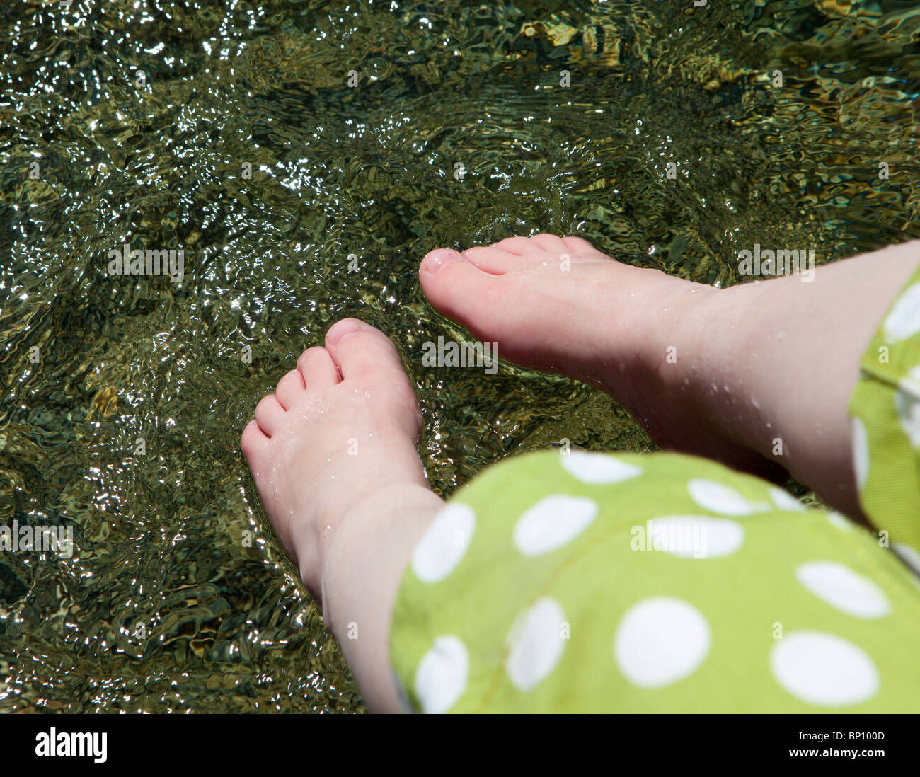 Child paddling in a mountain pool, Austria Stock Photo - Alamy