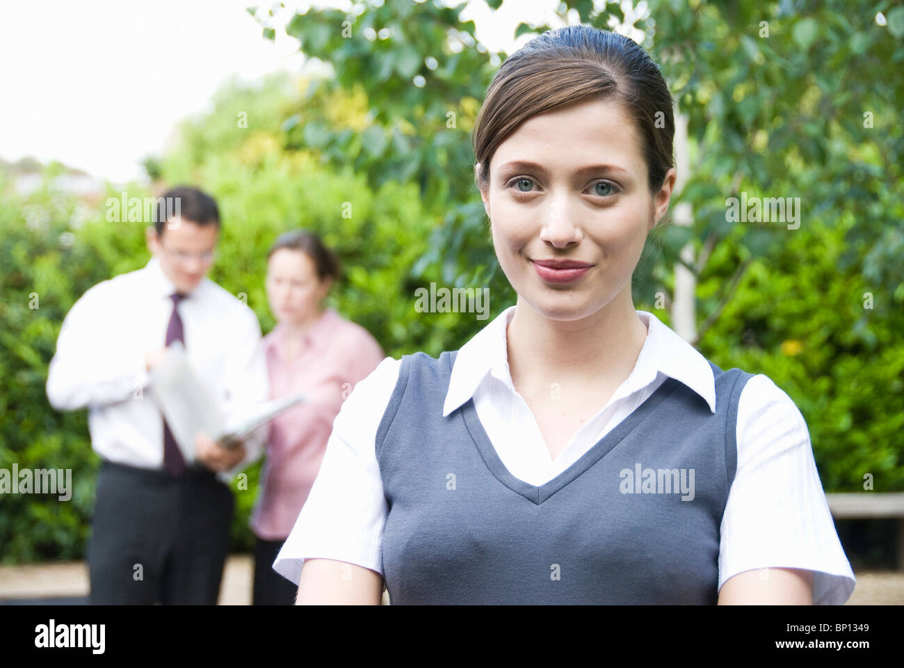Portrait of women with co workers Stock Photo - Alamy