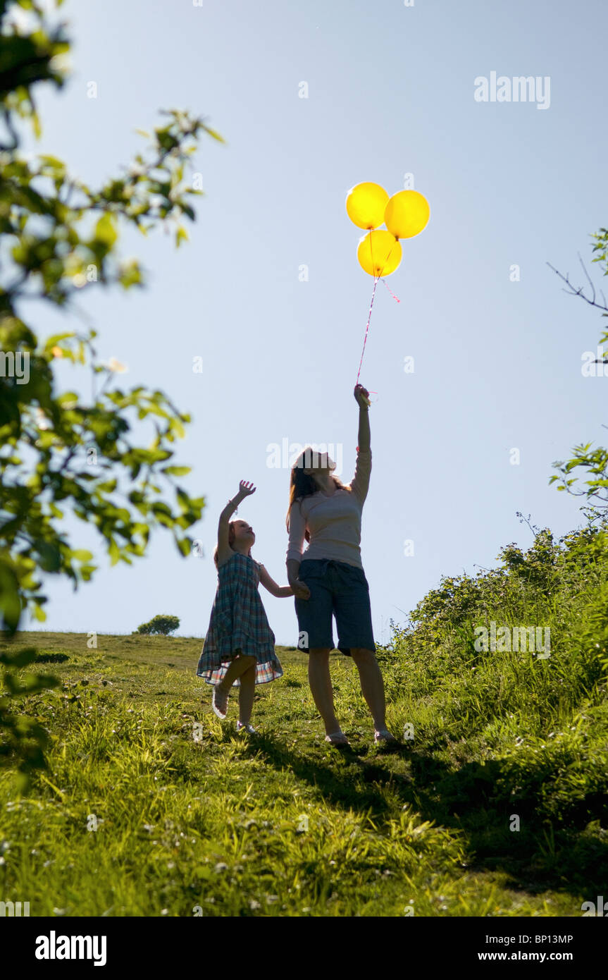 Woman and child look at balloons Stock Photo - Alamy