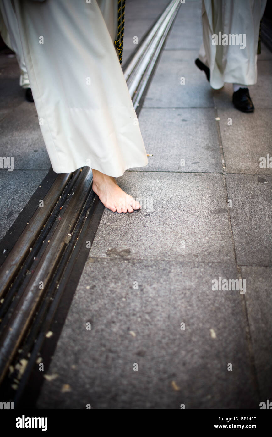 A barefoot member of a fraternity in a procession, Seville, Spain Stock ...