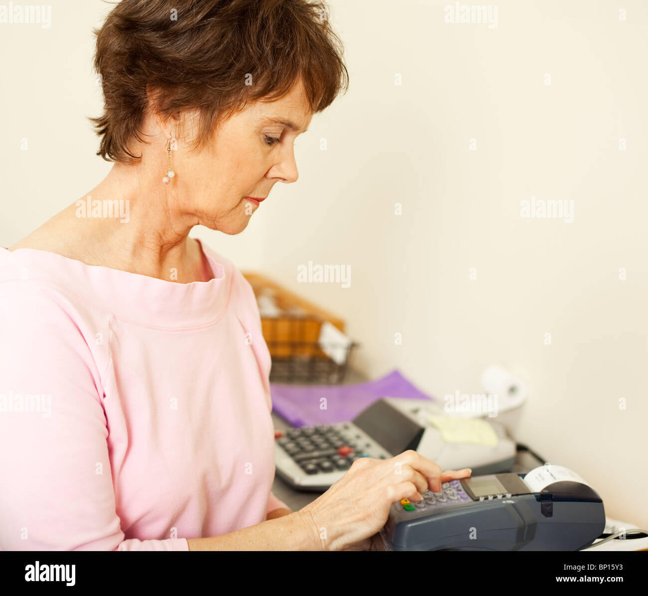 Store clerk types information into a credit card scanning machine Stock ...