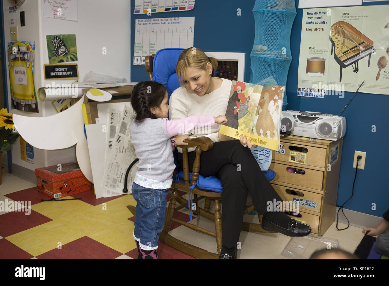 Preschool teacher reading to her student in the classroom Stock Photo ...