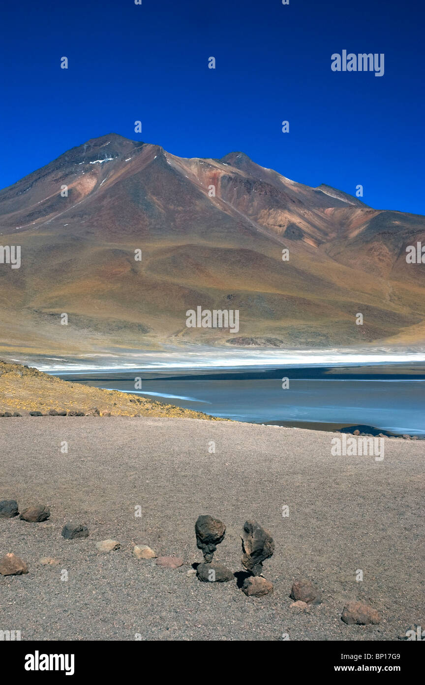 Volcan Miniques towers over the salt lake Laguna Miniques, in the Andes ...