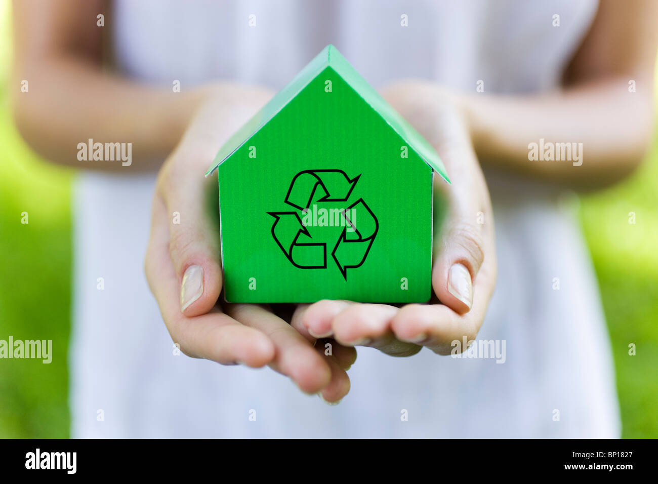 Young woman holding green model house with recycling sign Stock Photo ...