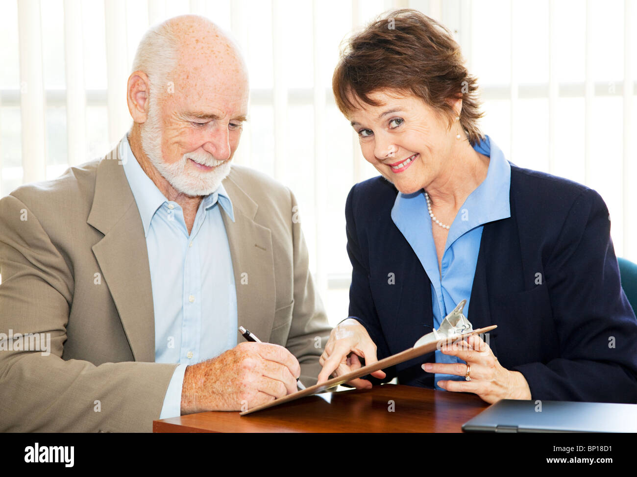 Successful saleswoman signs up a new client Stock Photo - Alamy