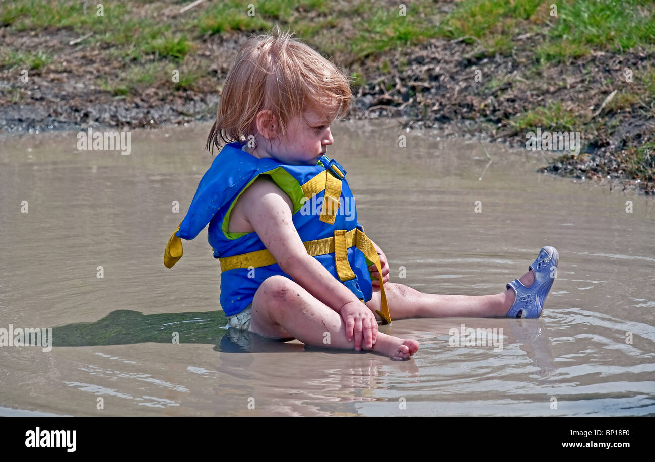 Kid sitting in puddle hi-res stock photography and images - Alamy