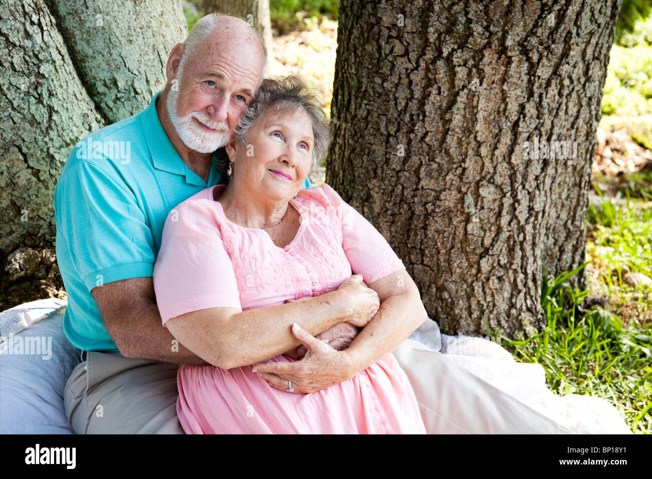 Nostalgic senior couple sitting outdoors and remembering Stock Photo ...
