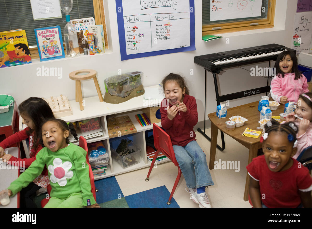 Preschool girls laughing in the classroom Stock Photo - Alamy