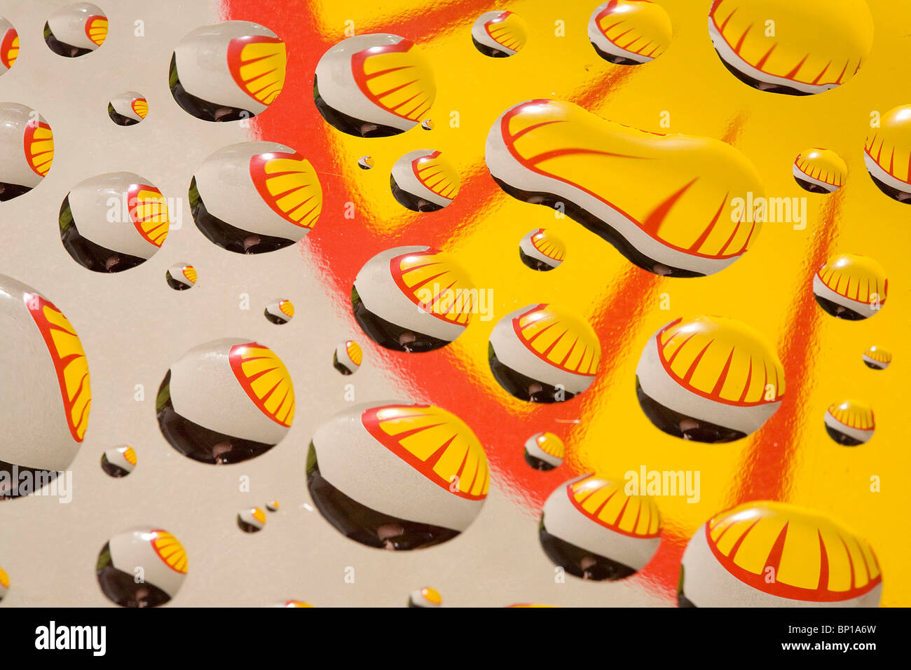 The Shell Oil logo is seen reflected in Oil Droplets on a car bonnet ...