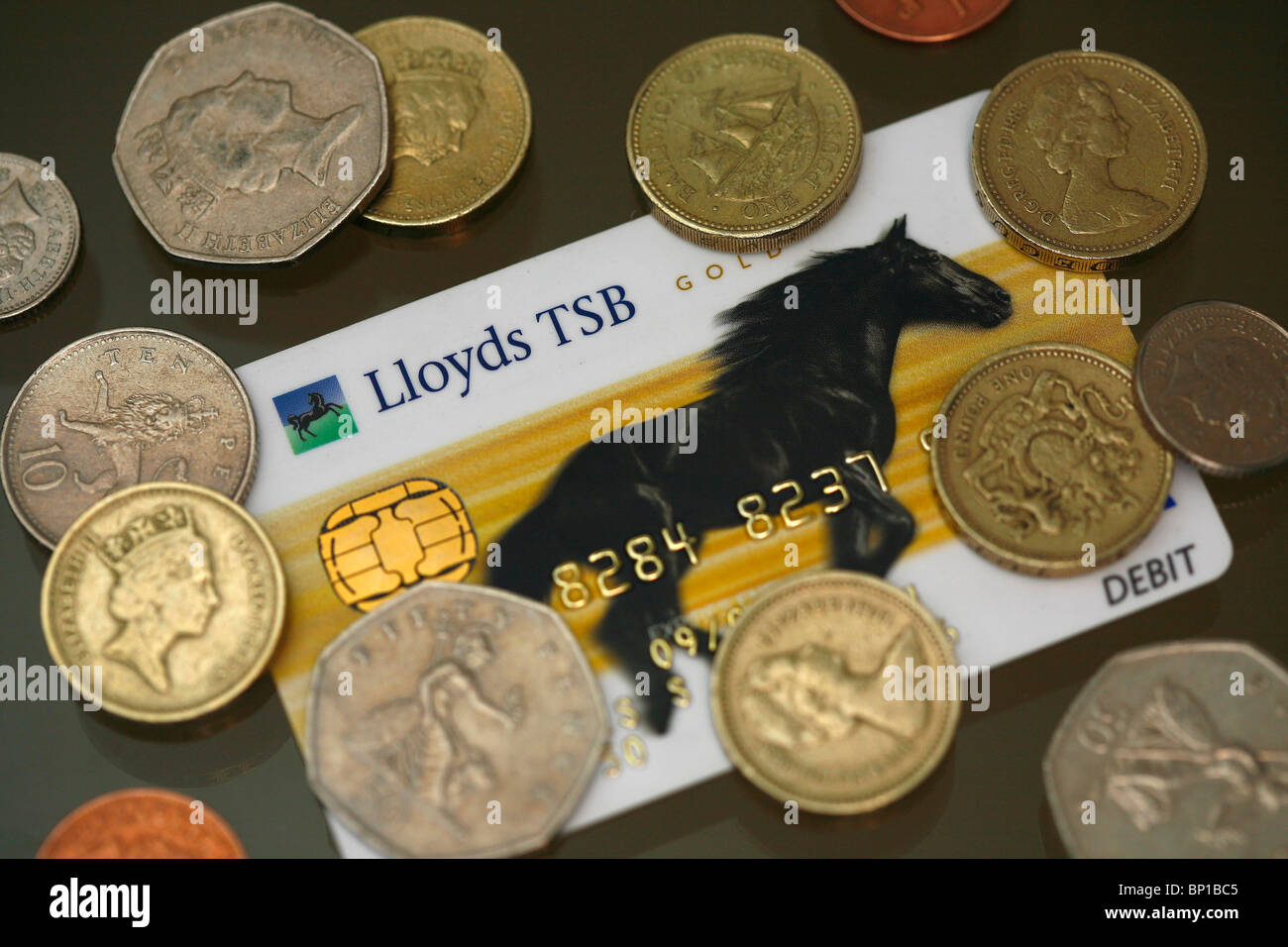 Lloyds TSB debit card and small change. Picture by James Boardman Stock ...