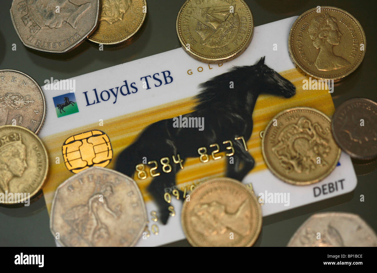 Lloyds TSB debit card and small change. Picture by James Boardman Stock ...