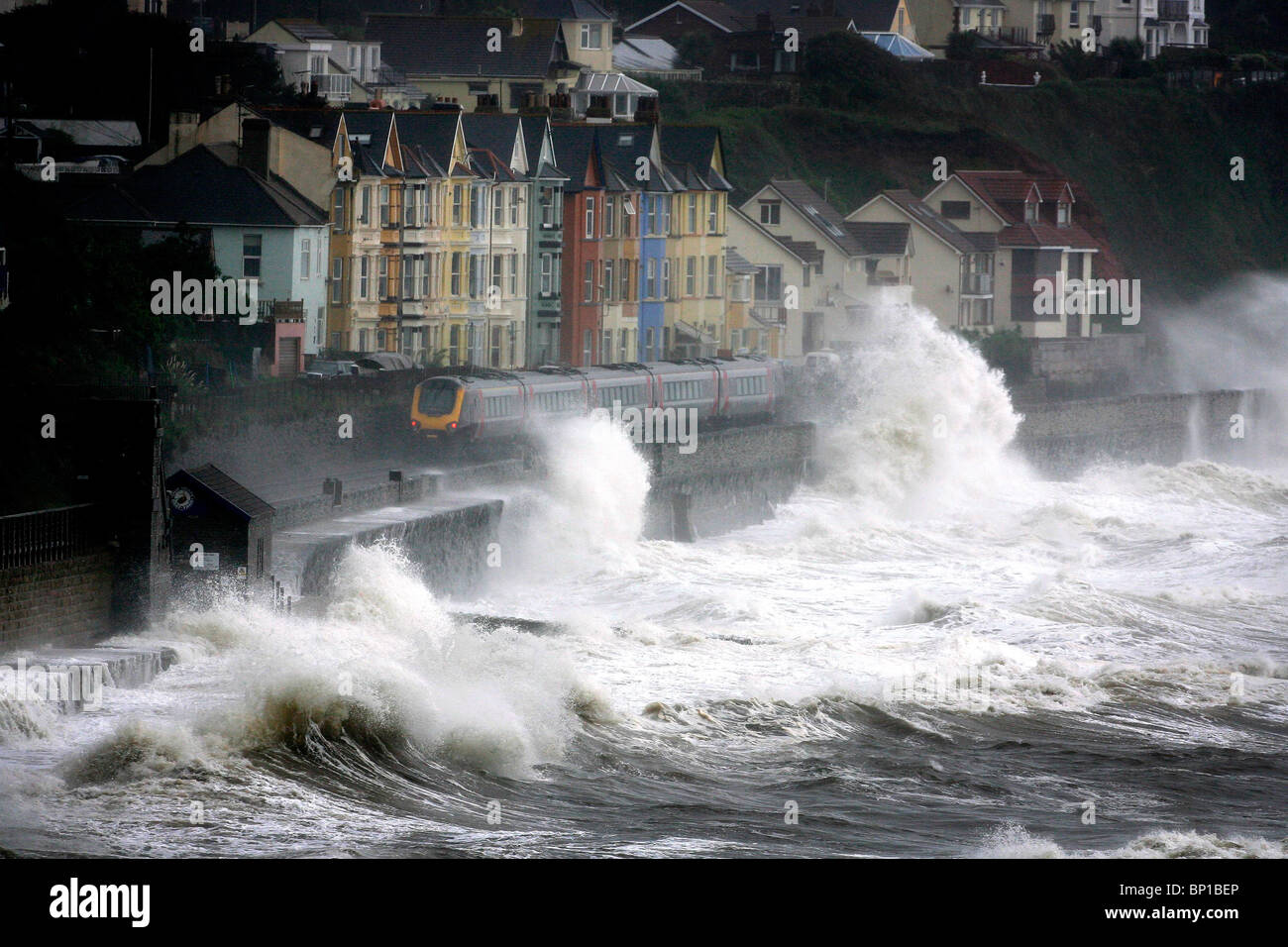 Huge waves crash over the sea wall and railway line at Dawlish in Devon ...