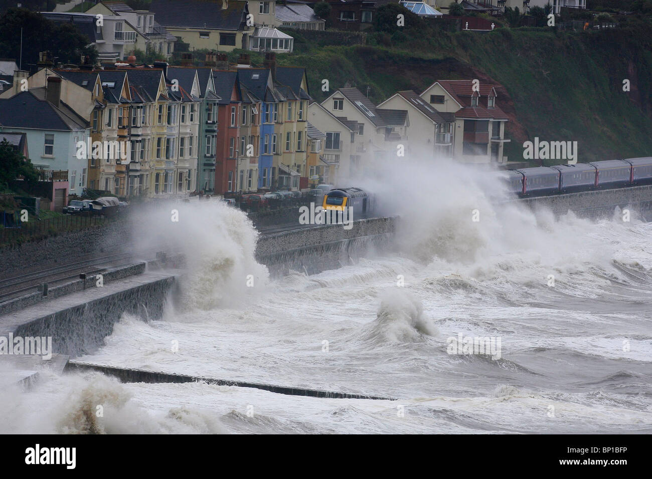 Huge waves crash over the sea wall and railway line at Dawlish in Devon ...