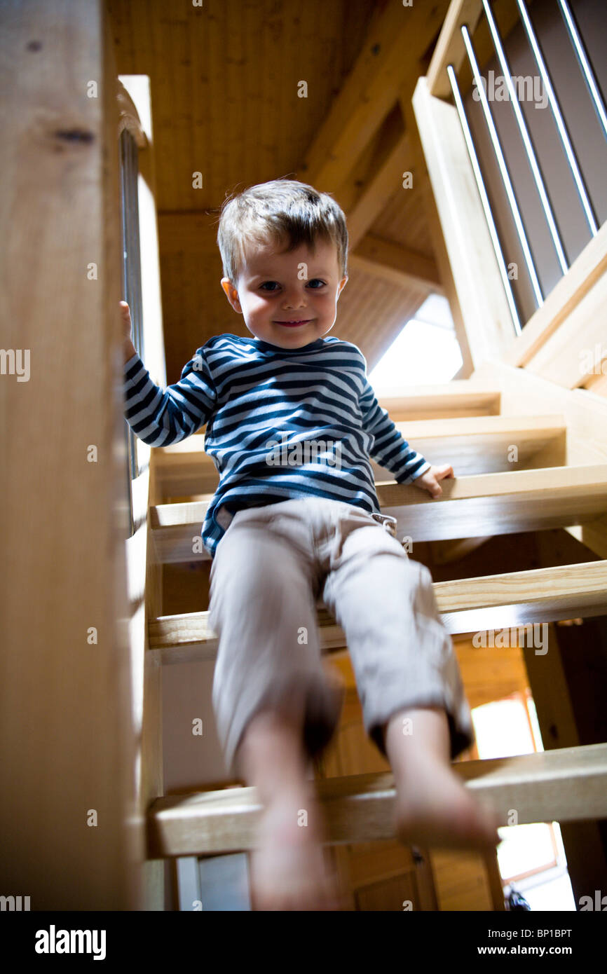 Little boy sitting on stairs Stock Photo - Alamy