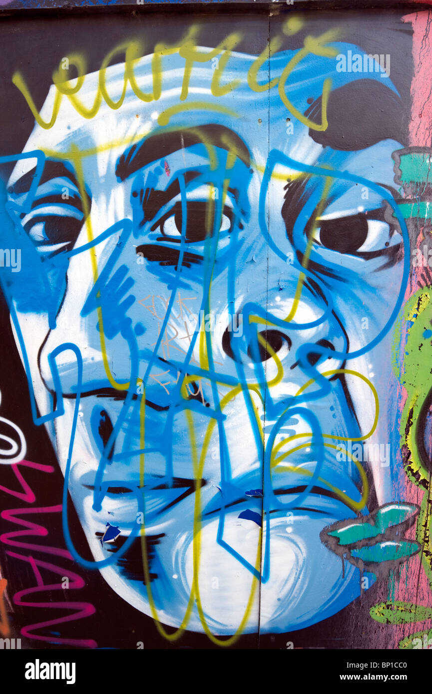 Street art graffiti and spray paint artistry on a derelict concrete ...