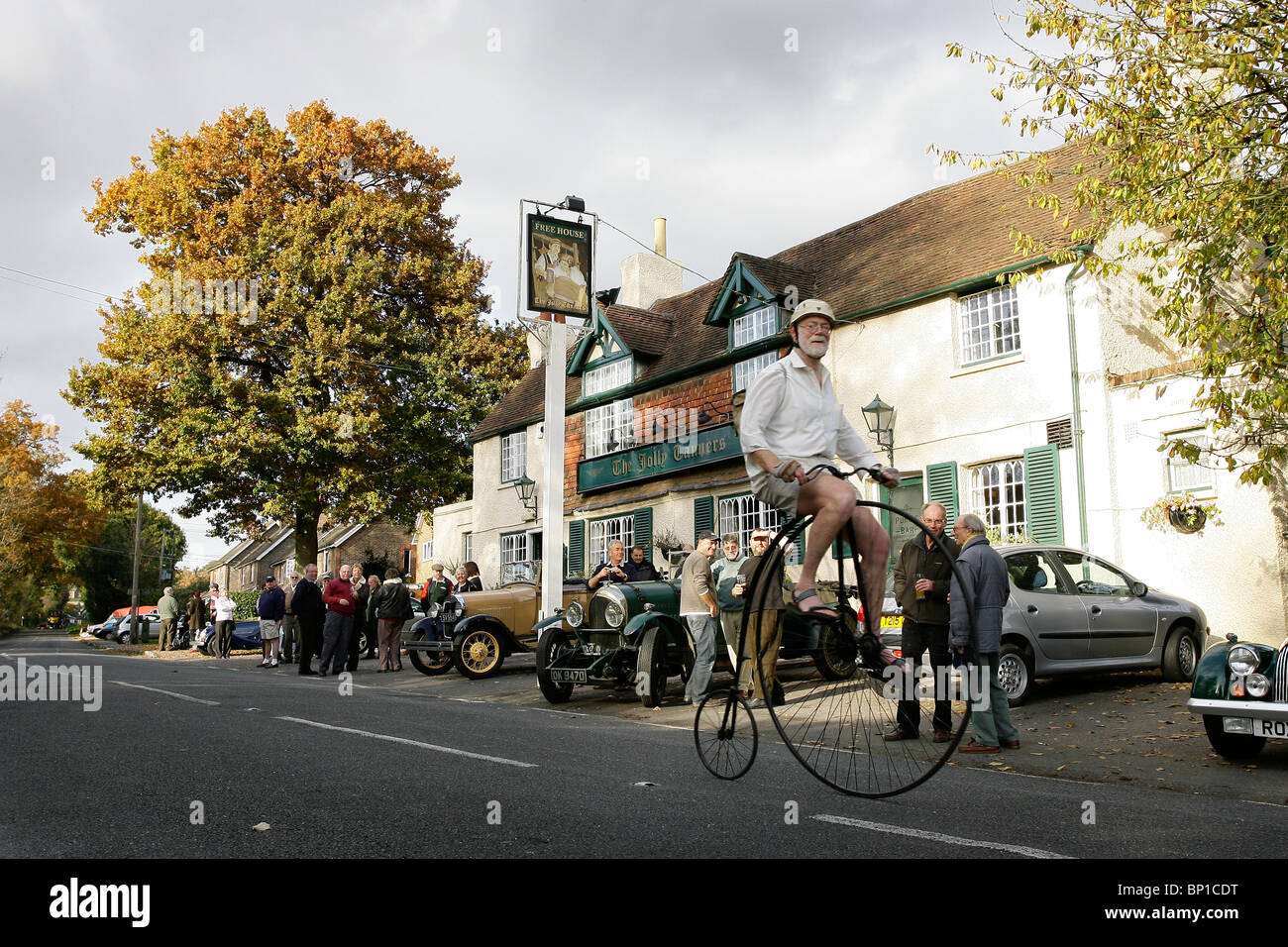 A man riding a Penny Farthing cycles past the Jolly Tanners Public ...
