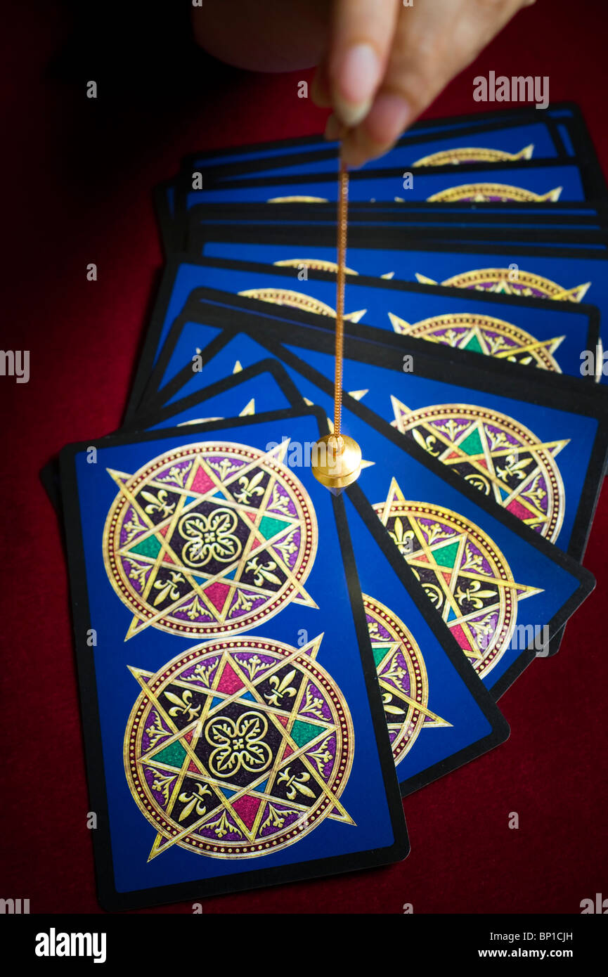 fortune teller hand during a tarot cards reading with pendulum Stock ...