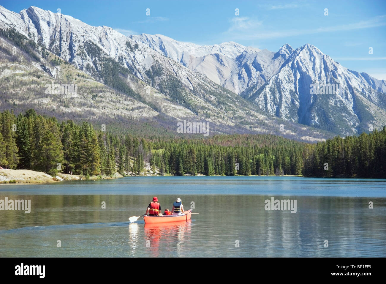 Banff National Park, Alberta, Canada; A Family Canoeing In Johnson Lake ...