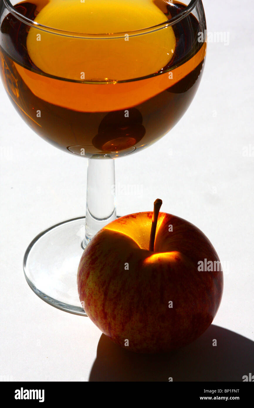 An apple and a glass of brandy Stock Photo - Alamy
