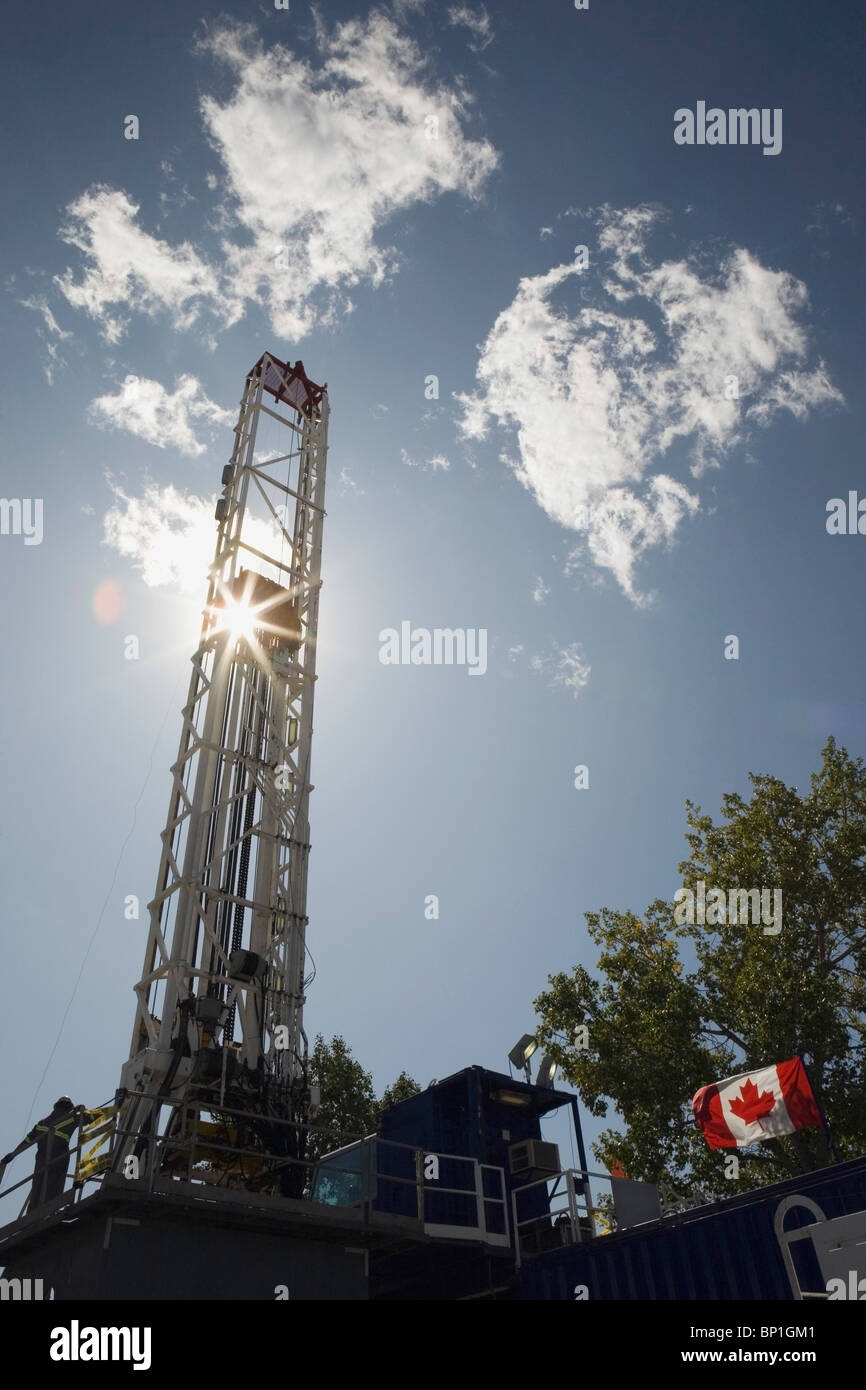 Calgary, Alberta, Canada; A Drilling Rig With A Sunburst Stock Photo ...