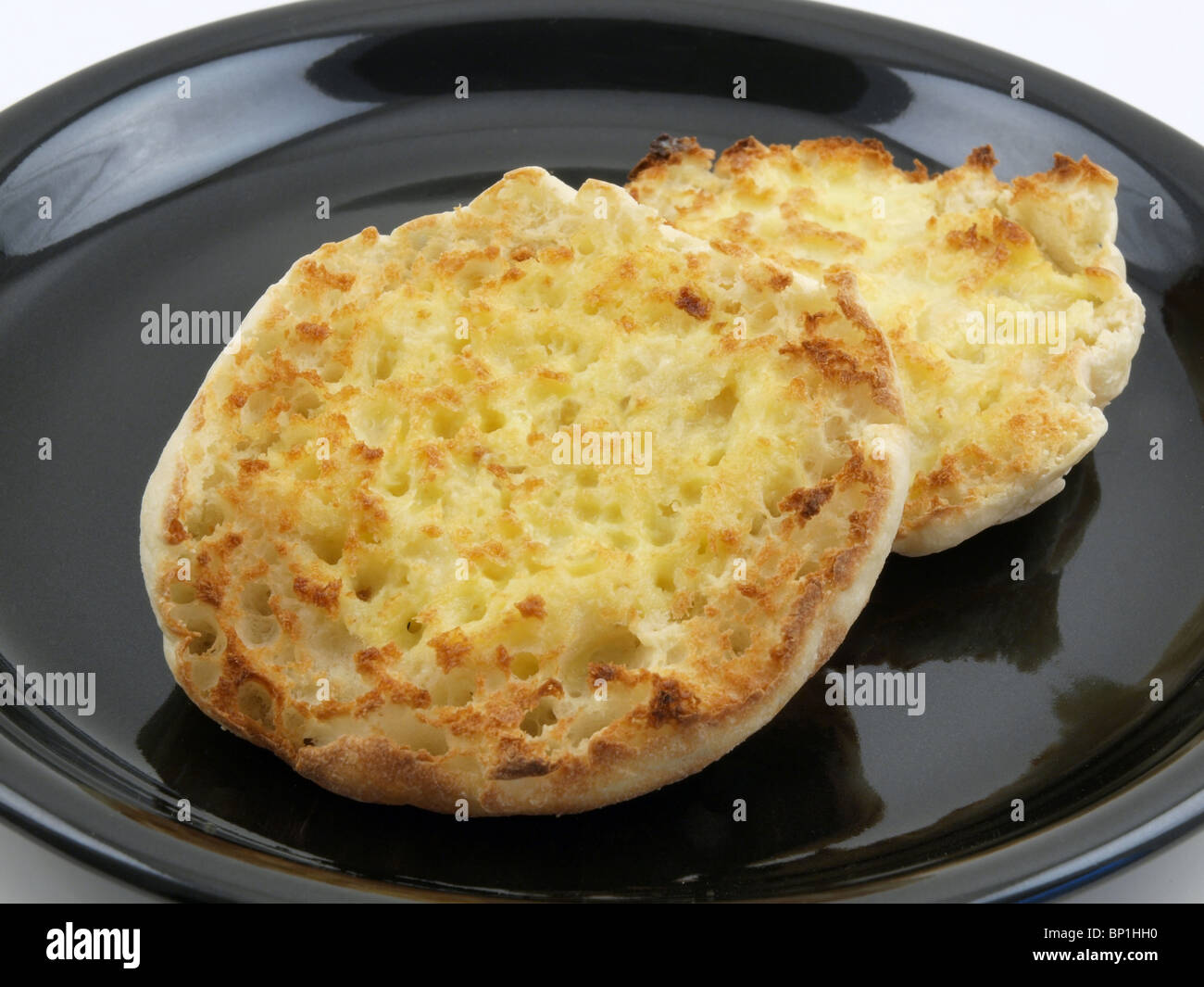 English Muffin, buttered, toasted, ready to eat Stock Photo - Alamy
