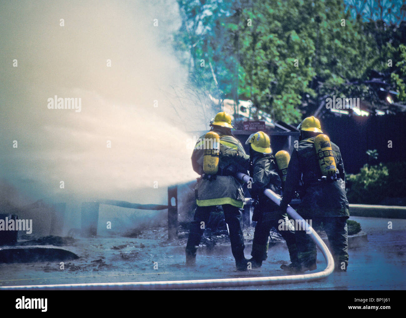 Fire men in action at accident scene Stock Photo - Alamy