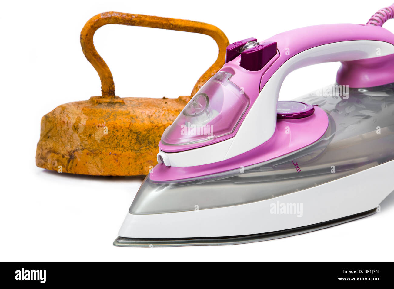 Old rusty pig-iron iron and modern new electric iron on white ...