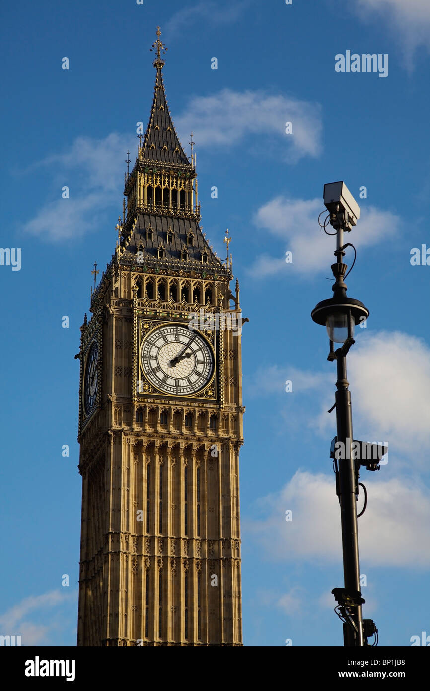 A Clock Tower With A Spire And A Lamp Post Stock Photo - Alamy