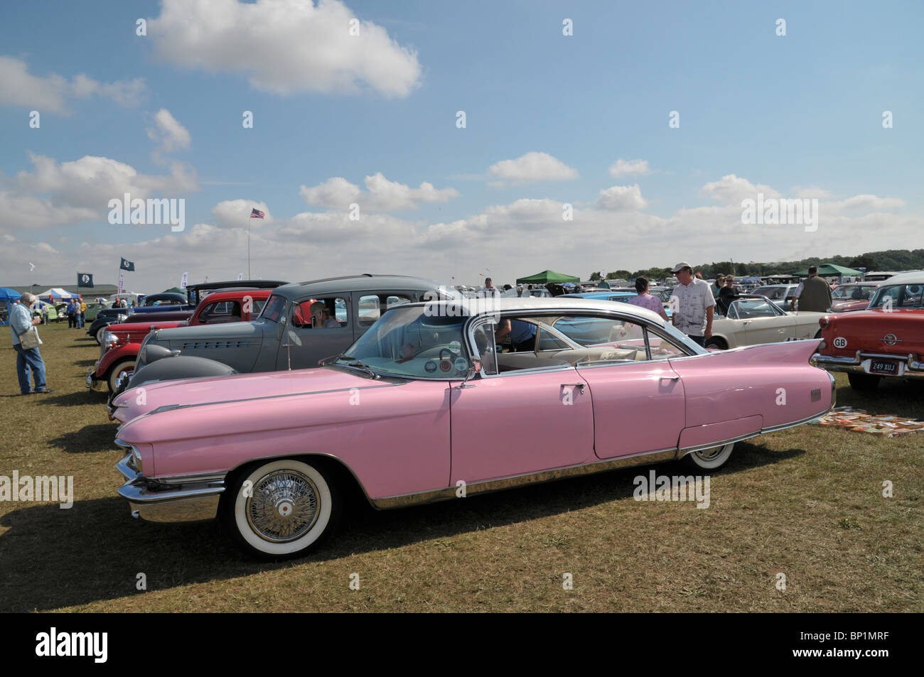 a pink cadillac on show with other classic cars at the steam rally ...