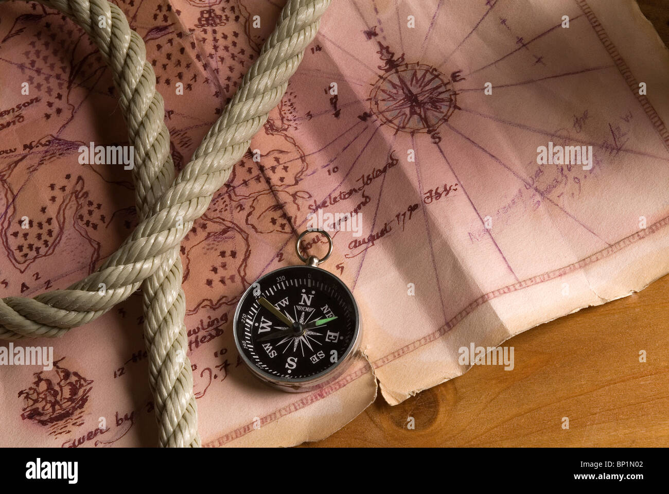 Marine map, compass and rope Stock Photo - Alamy