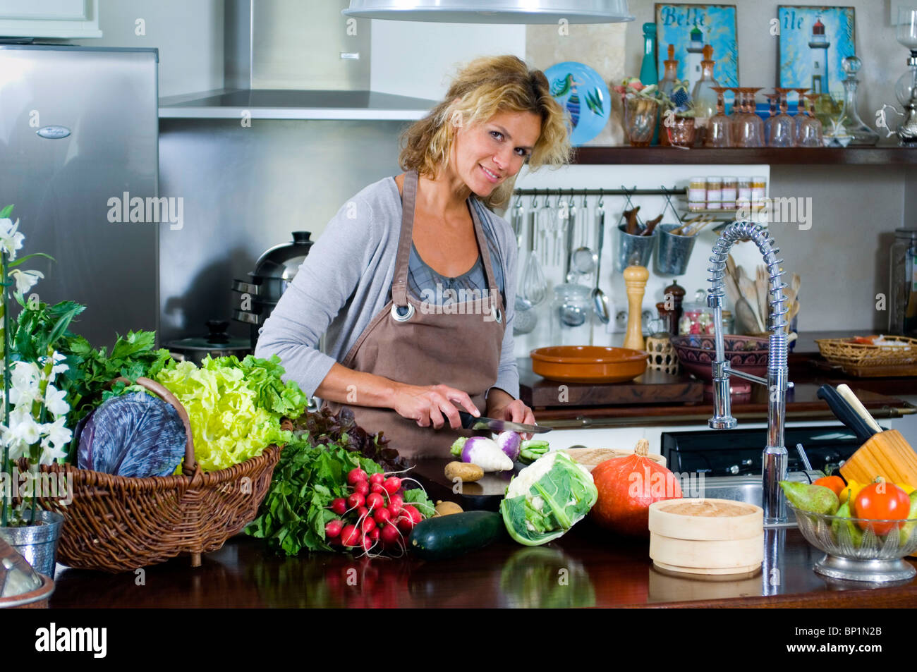 Woman cooking in kitchen Stock Photo - Alamy