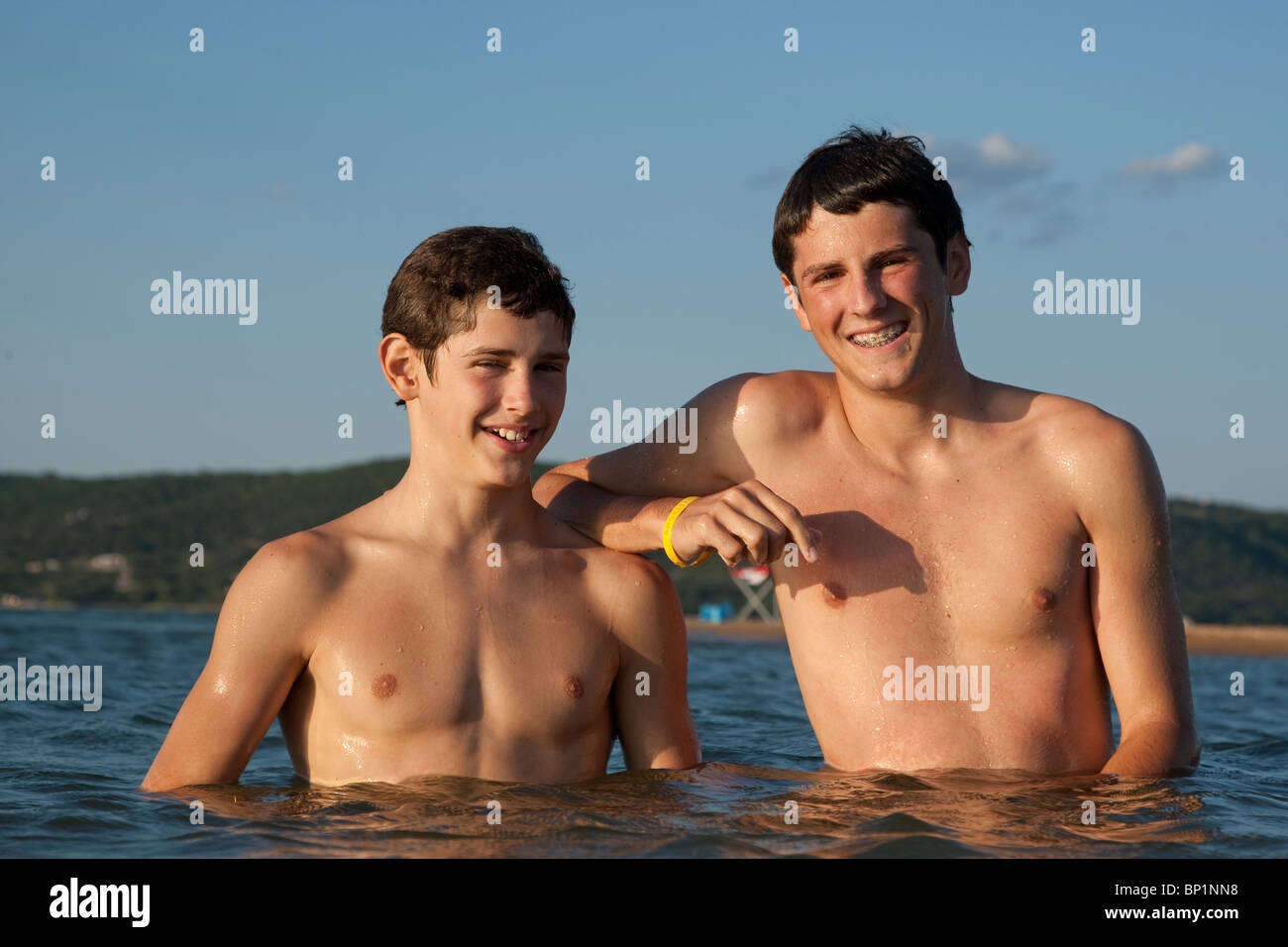 Anglo brothers, 13 and 16, pose on beach at Lake Buchanan in Central ...