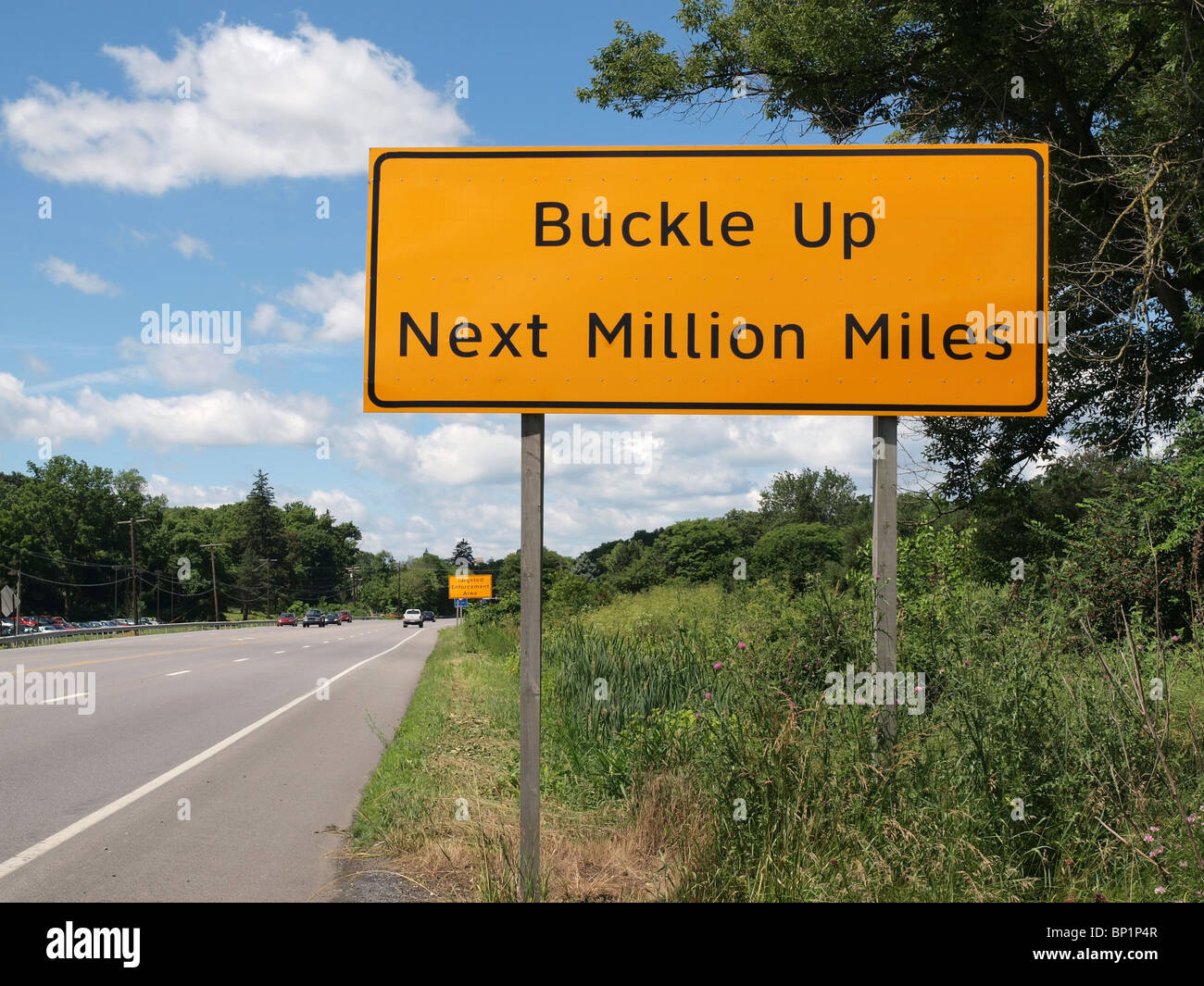 Buckle Up Next Million Miles highway sign Stock Photo - Alamy