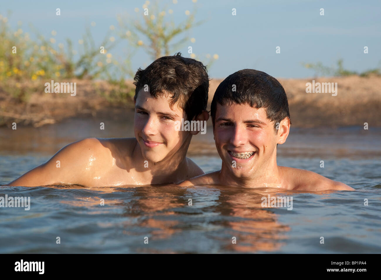 Anglo brothers, 13 and 16, pose on beach at Lake Buchanan in Central ...