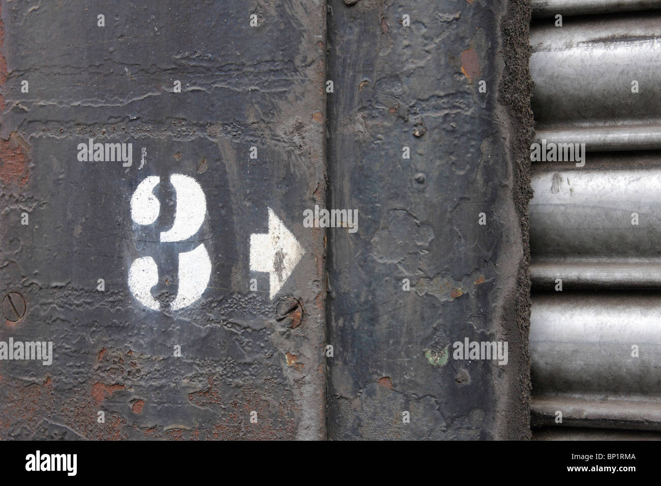 Detail of stenciled number three on side of building Stock Photo - Alamy