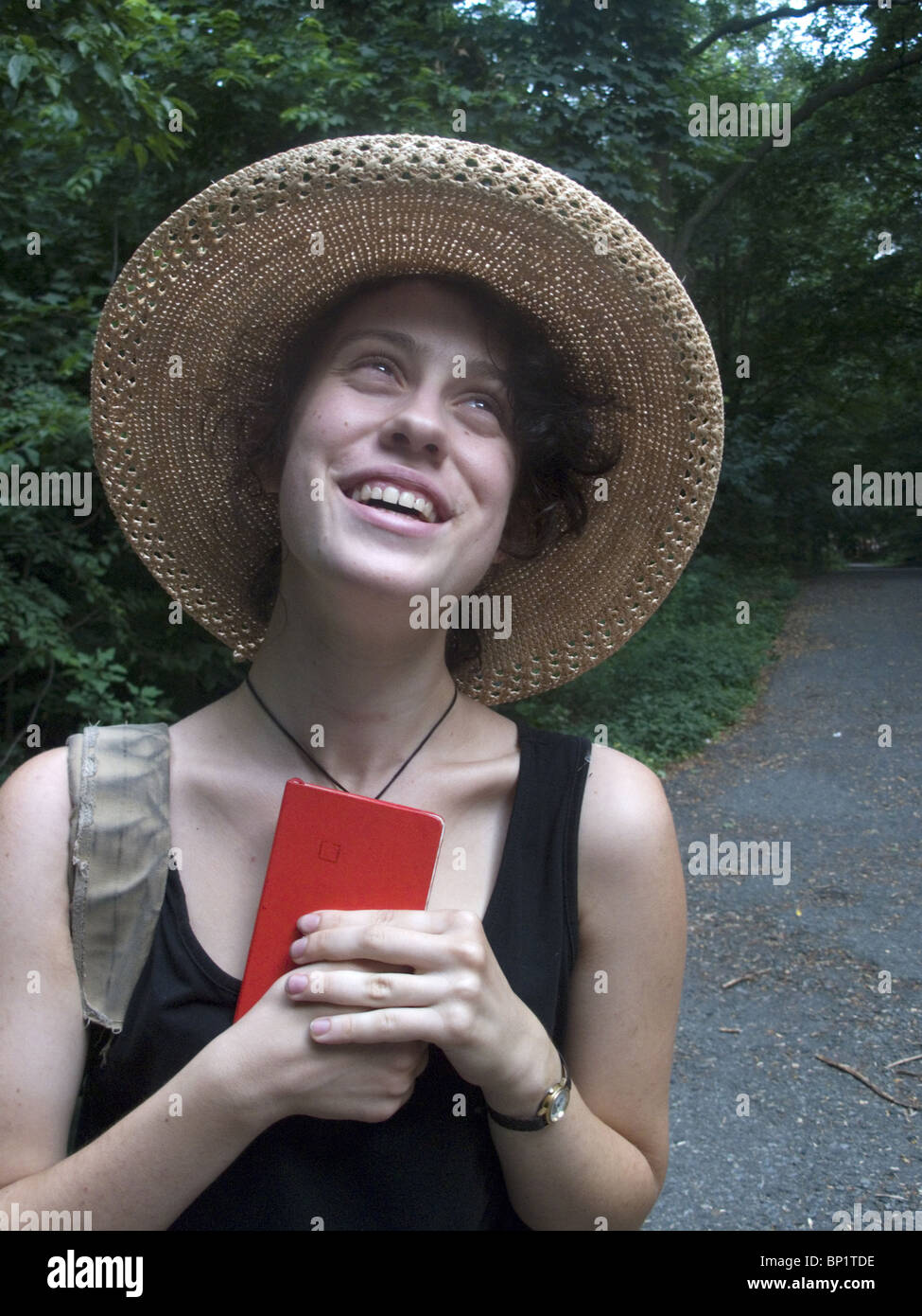 Woman smiling holding hat hi-res stock photography and images - Alamy