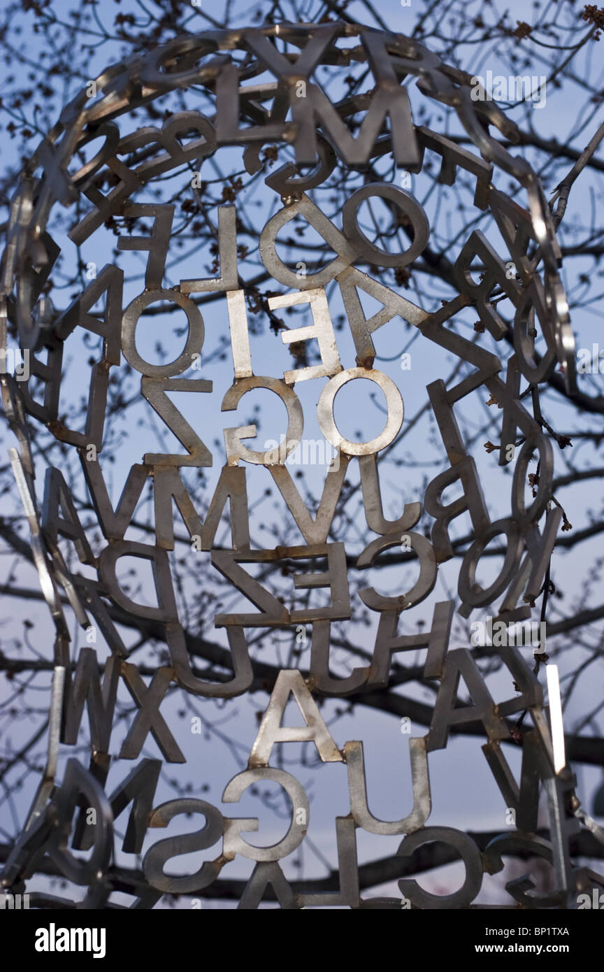 Sitting man made of metal letters statue at Montreal Port, Quebec ...