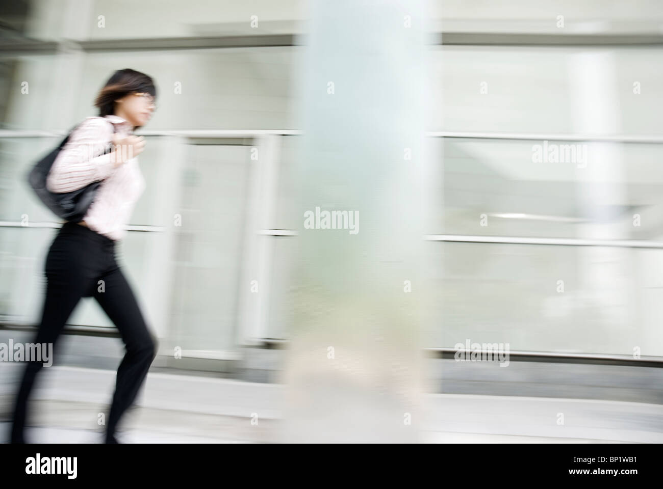 Slow motion female employee walking hi-res stock photography and images ...