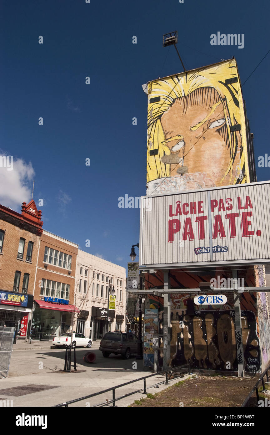 Lache Pas La Patate sign with graffiti building at St Catherine Street ...