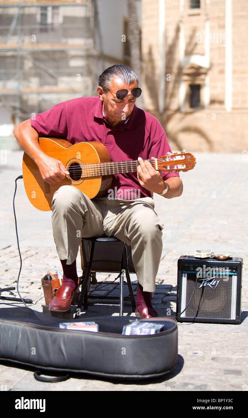 busker playing classical spanish guitar in the square in front of Cadiz ...