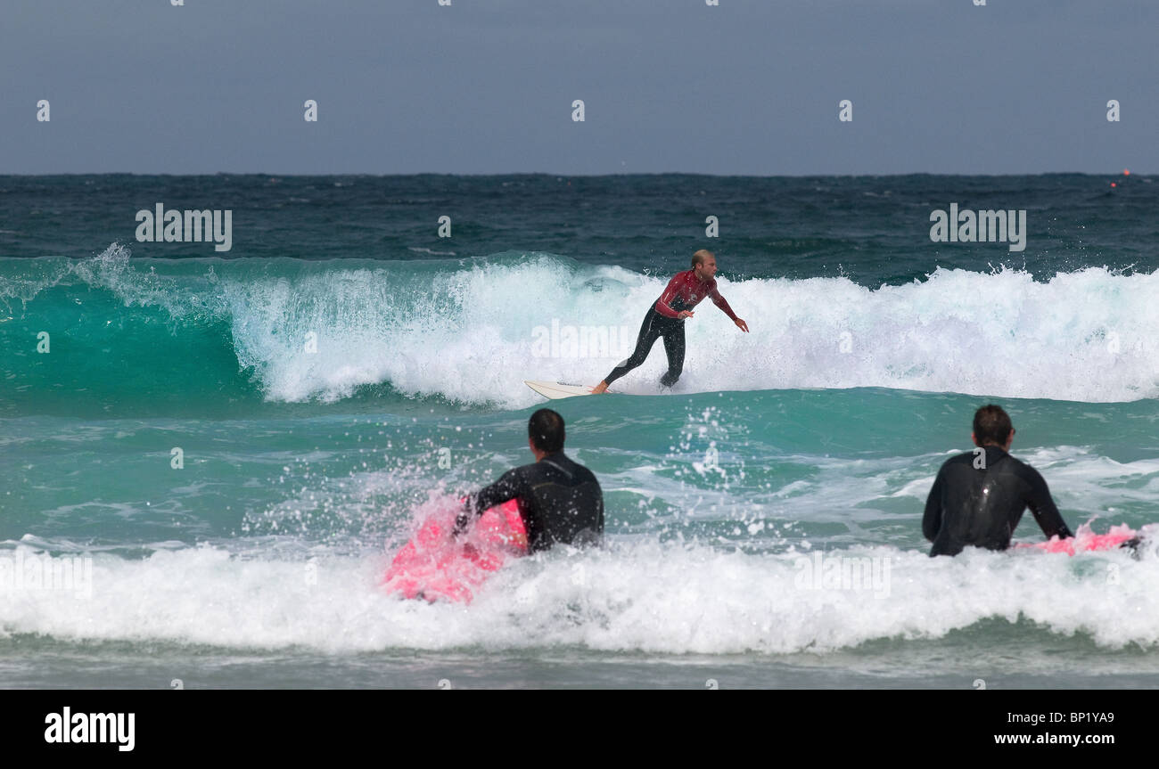 Surfers in the sea off the coast of Newquay in Cornwall. Photo by ...