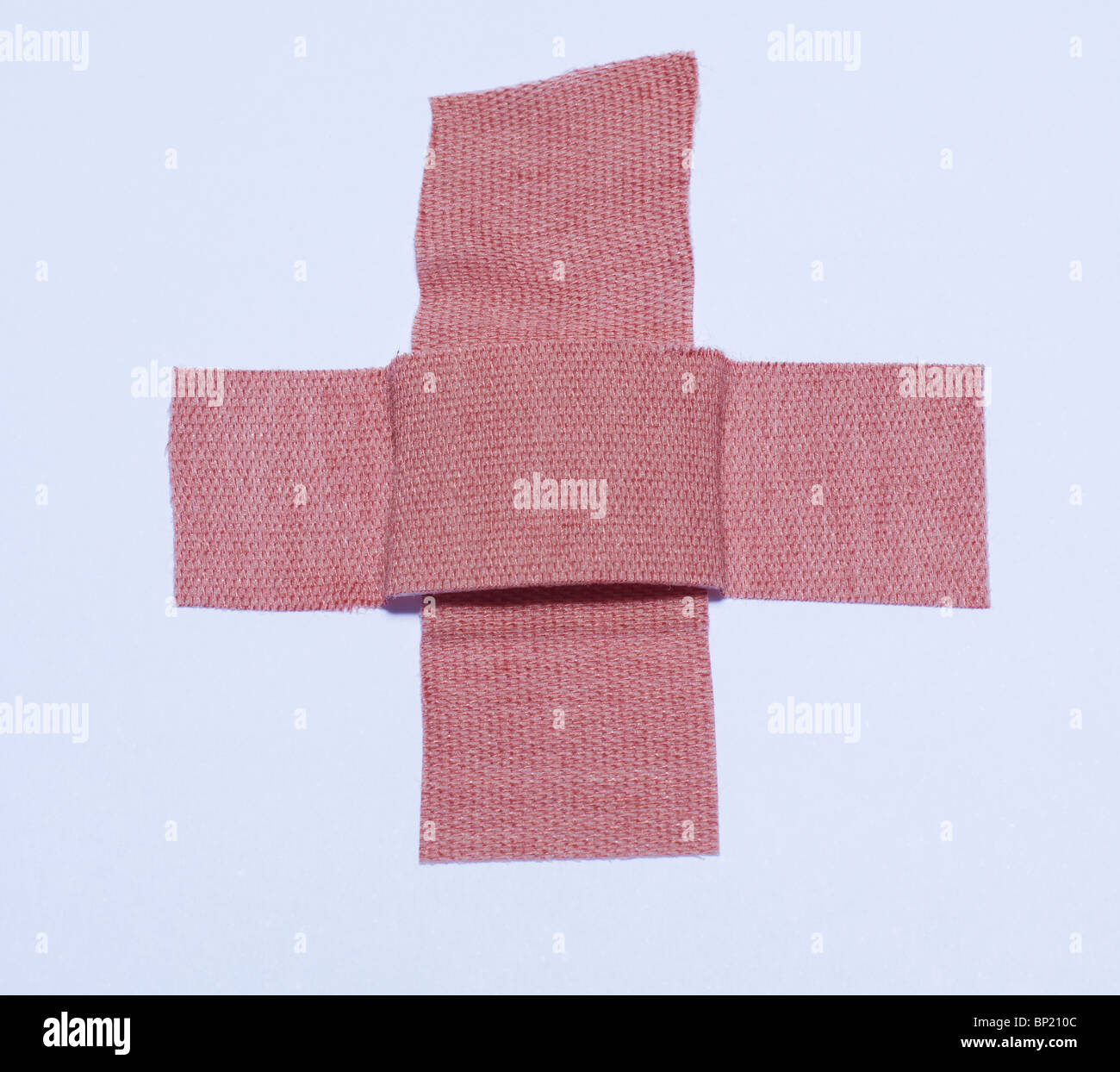 First aid sticking plasters in the shape of an + symbol Stock Photo - Alamy