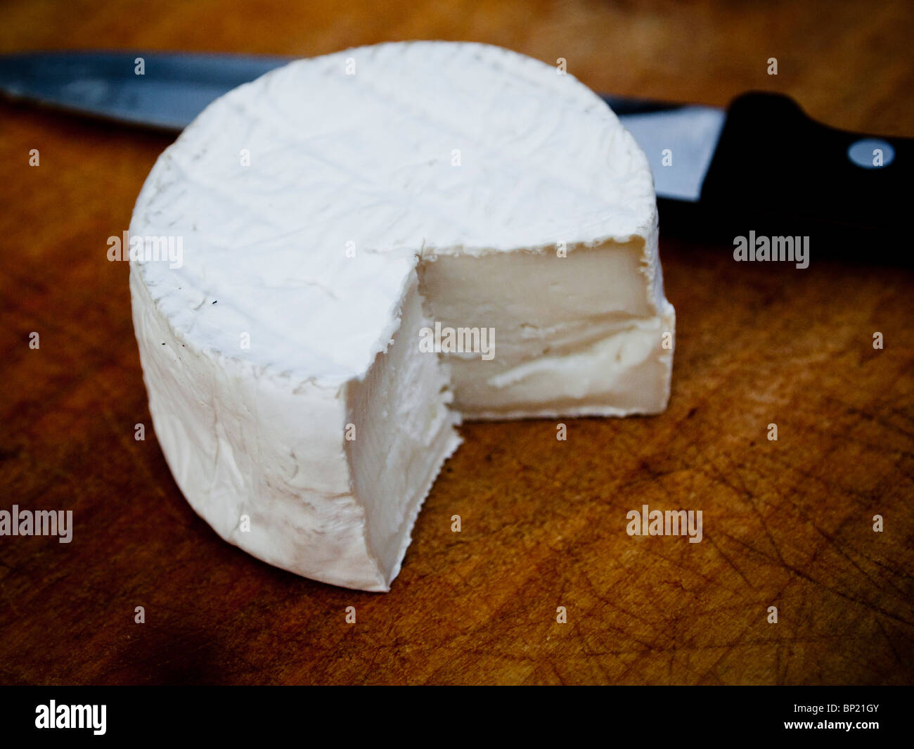 Little whole goat's cheese cut open to show creamy interior Stock Photo ...